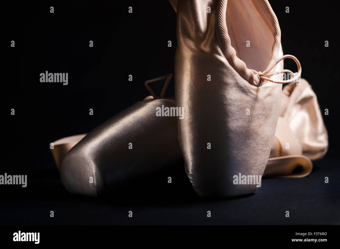 Pointe shoes over black background Stock Photo - Alamy