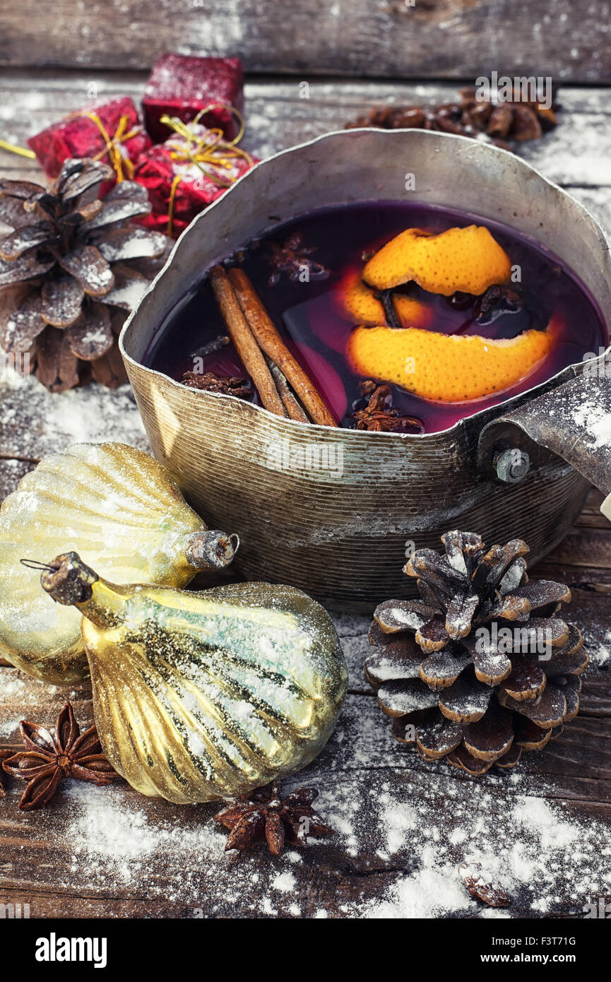 The old pot of fragrant mulled wine on the background of Christmas ...