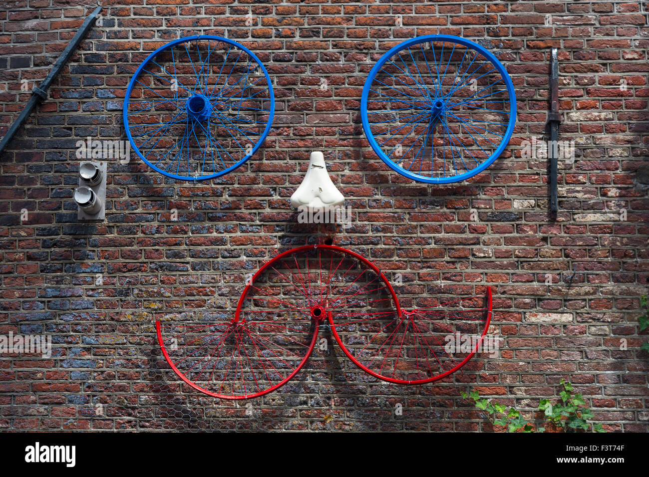 Face wall art made from push bike wheels and saddle in Bethanienstraat ...