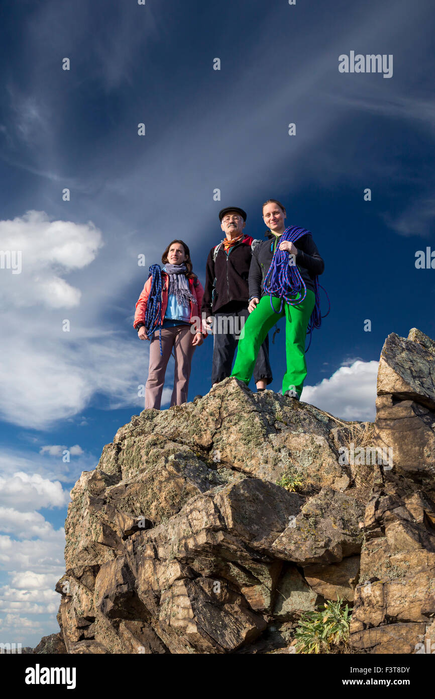 Group of climbers stays on the pointed cliff Stock Photo - Alamy