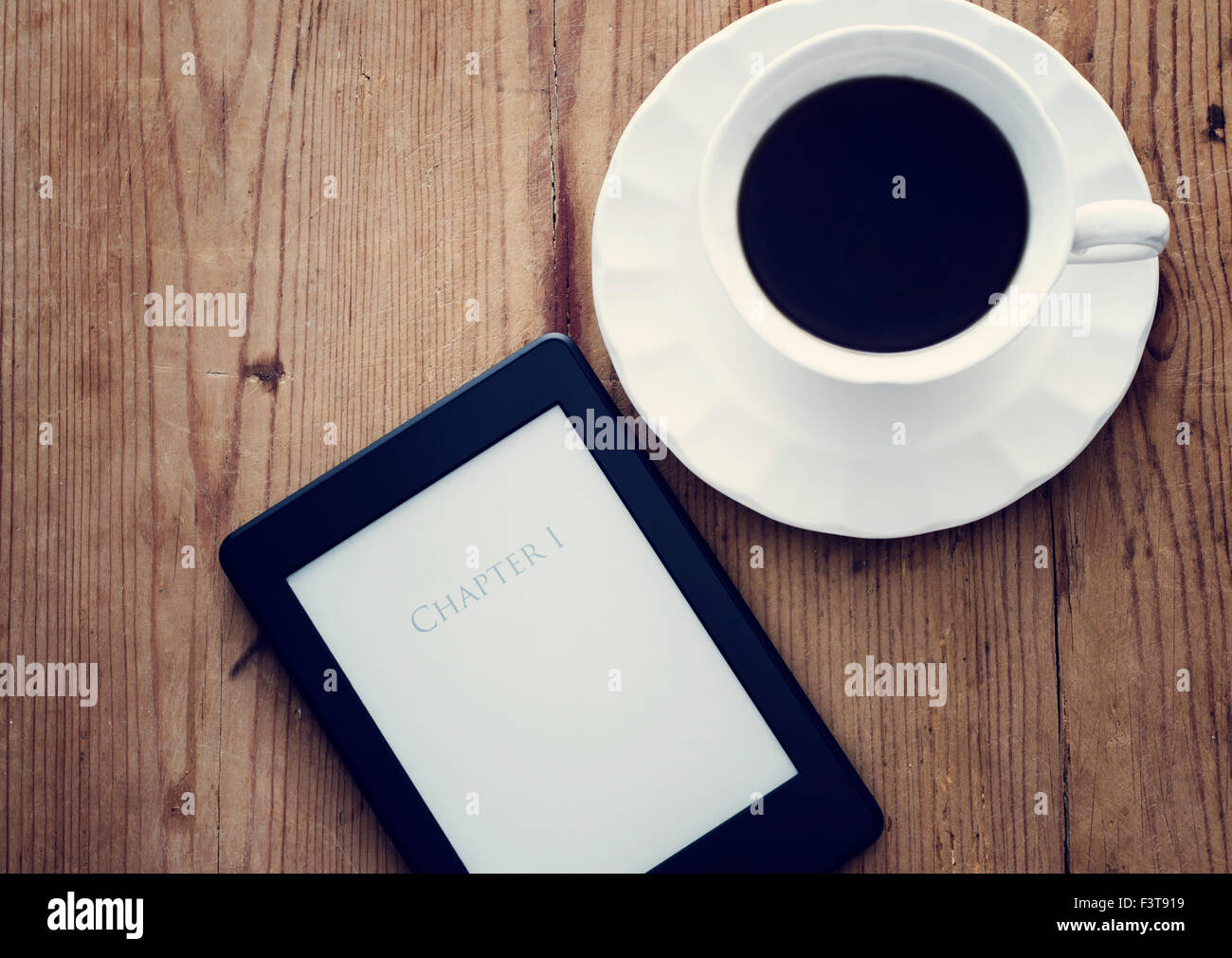 E-book reader and coffee cup on wooden table Stock Photo - Alamy