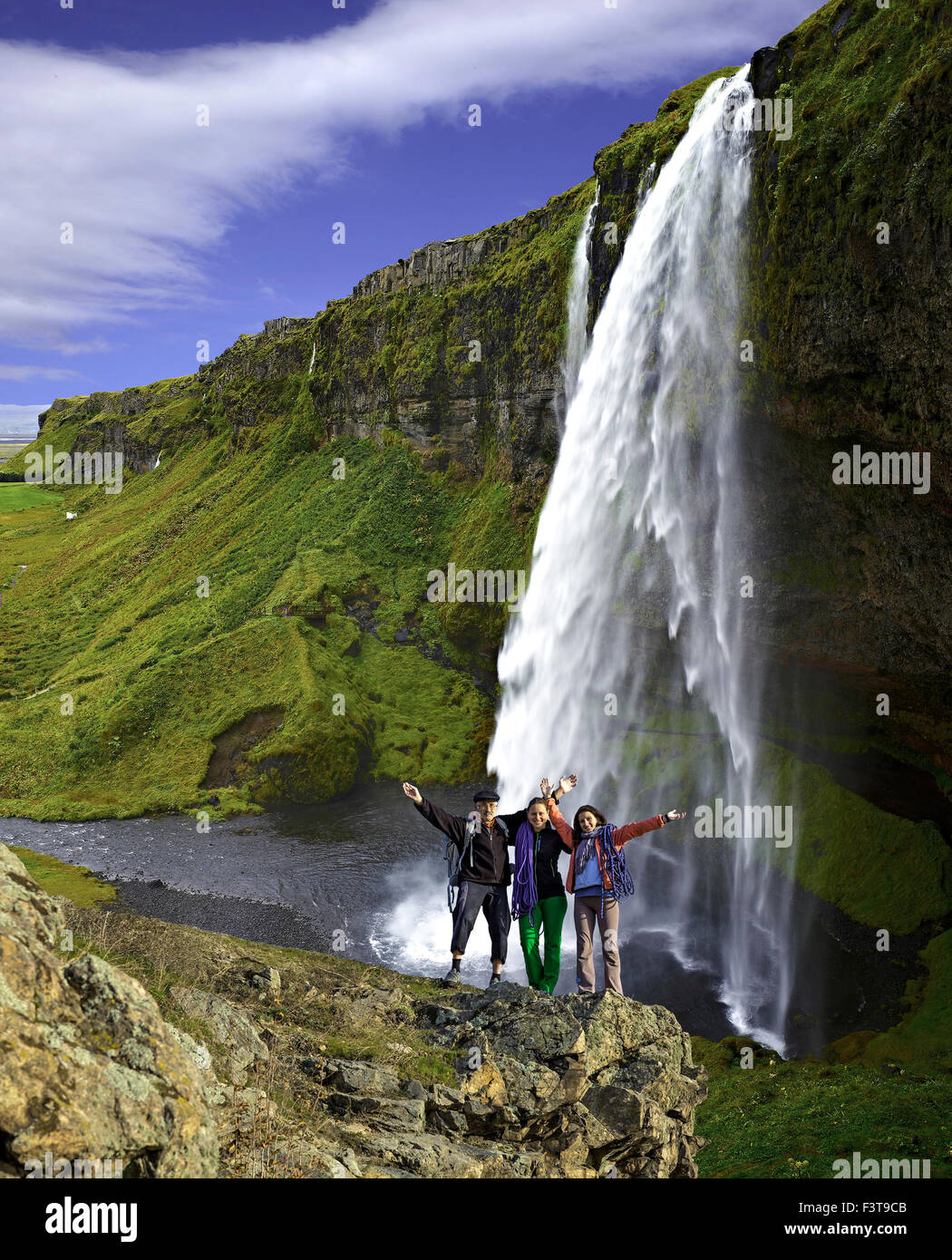 Group of climbers on the waterfall background Stock Photo - Alamy