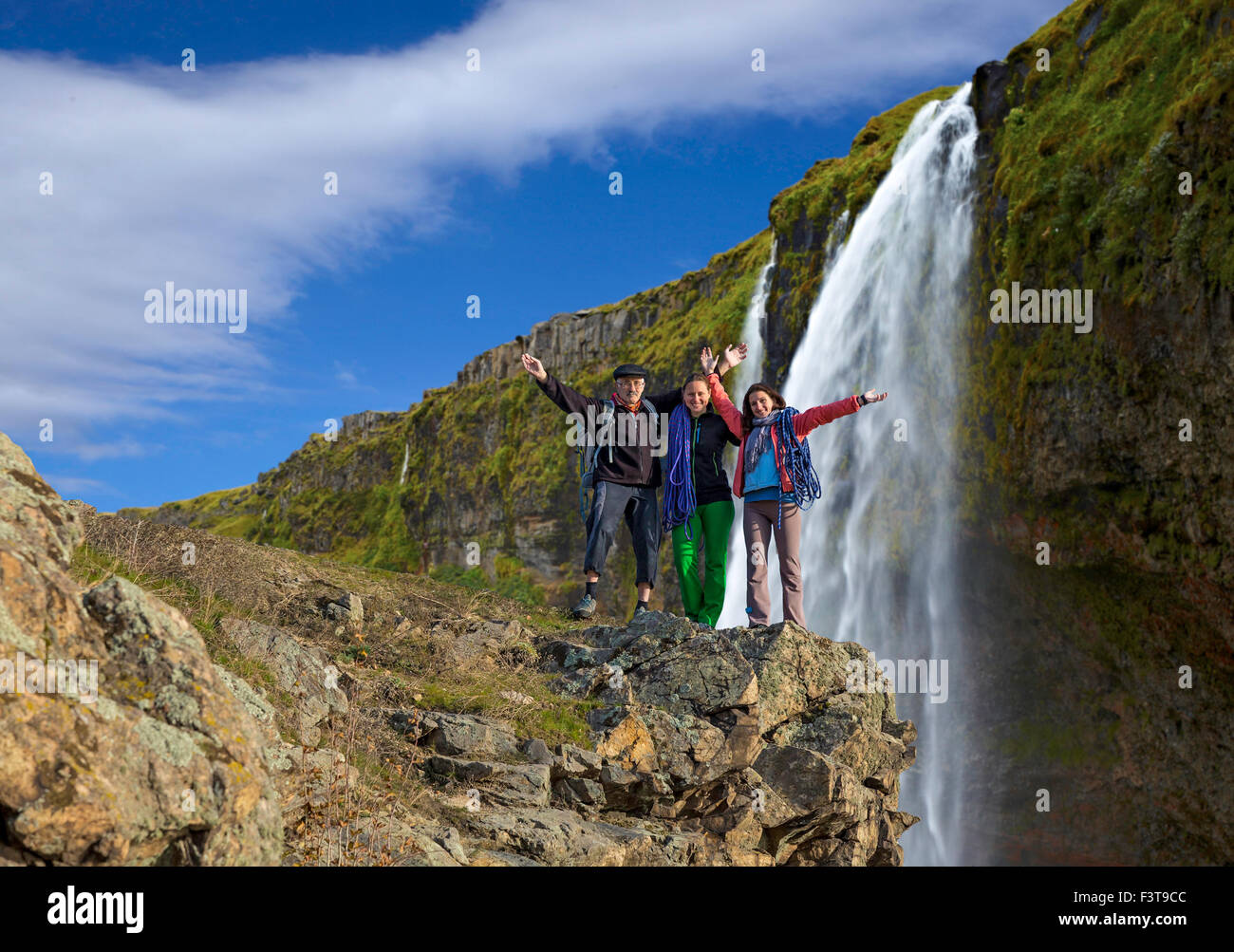 Group of climbers on the waterfall background Stock Photo - Alamy
