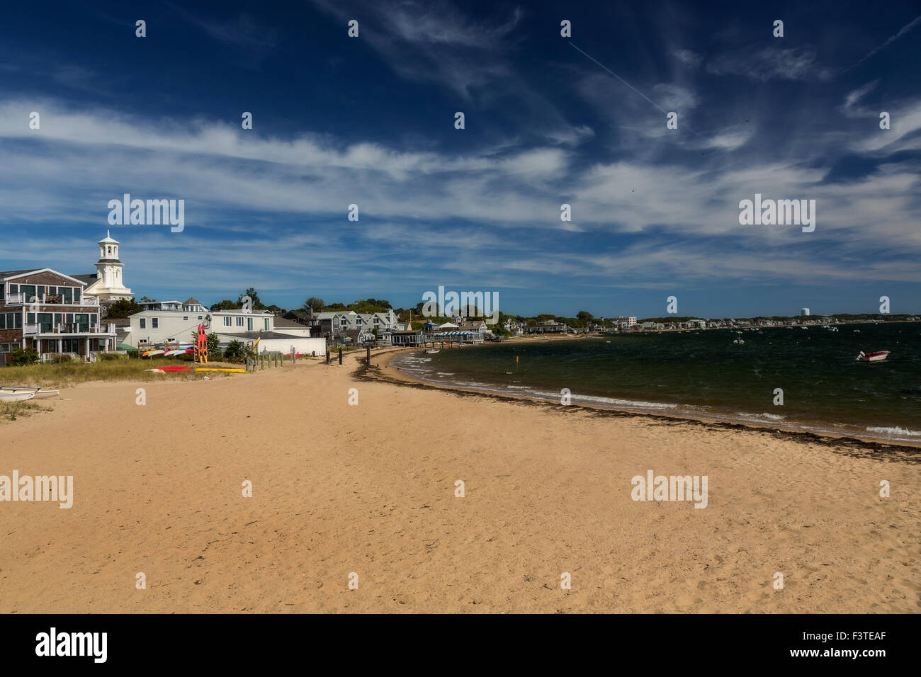 Beach and coastline with boats and architecture in the distance ...