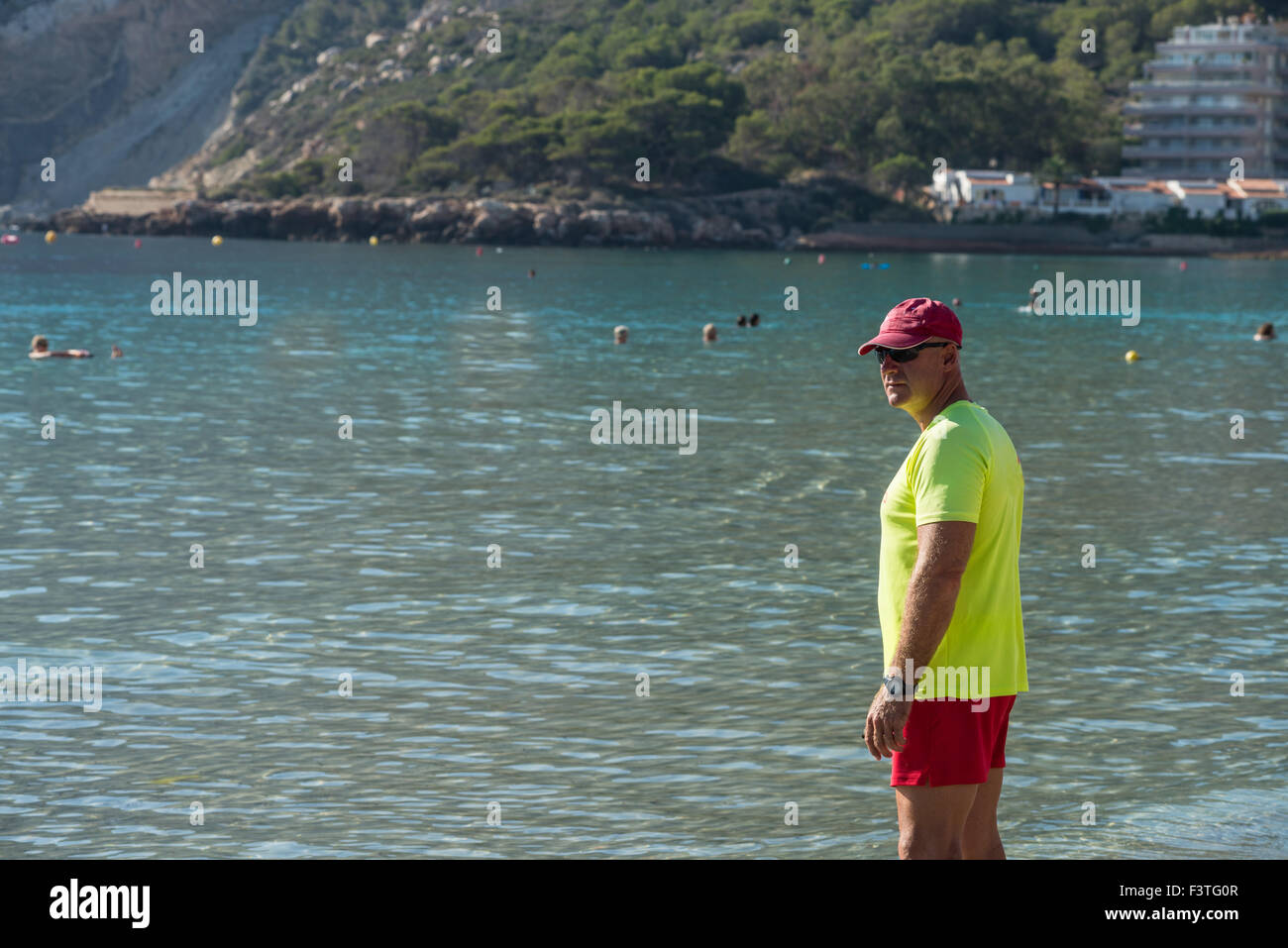 Lifeguard standing on the shore of a beach resort Stock Photo - Alamy