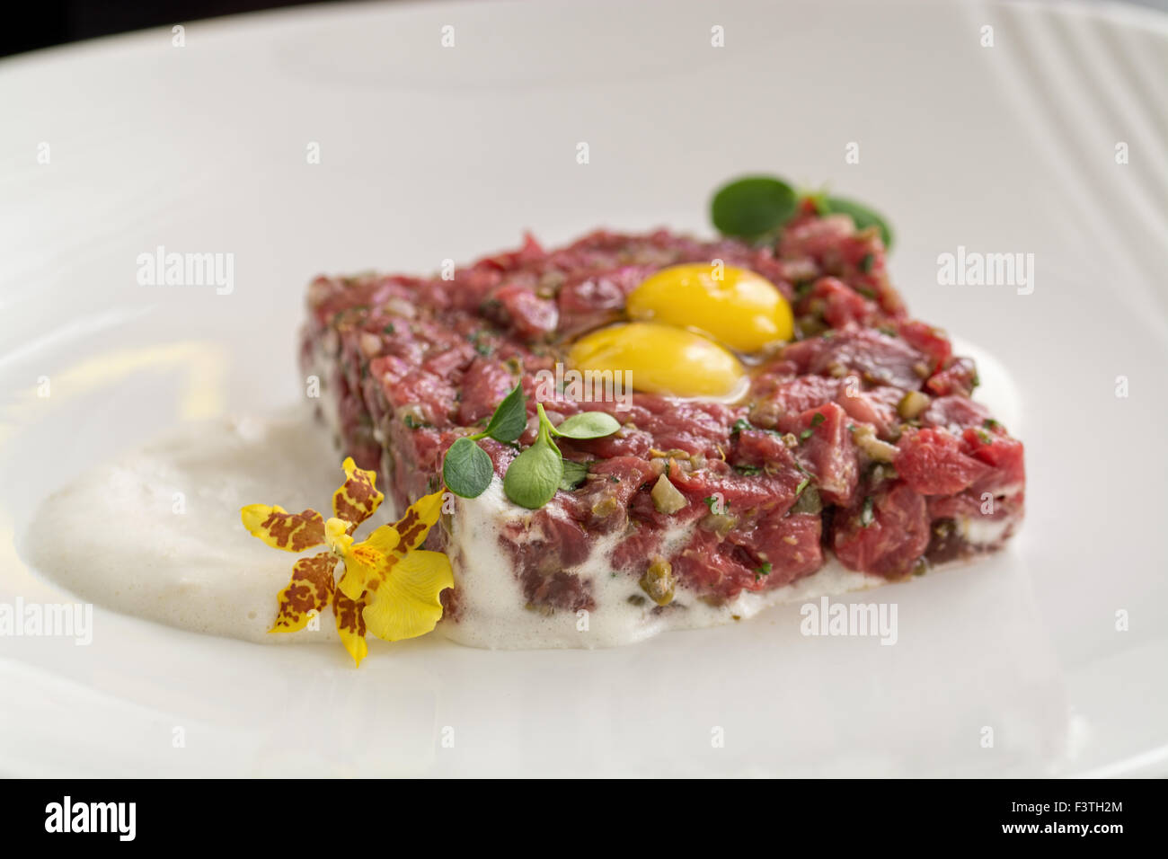 gourmet steak tartar with seasoning on white background Stock Photo - Alamy