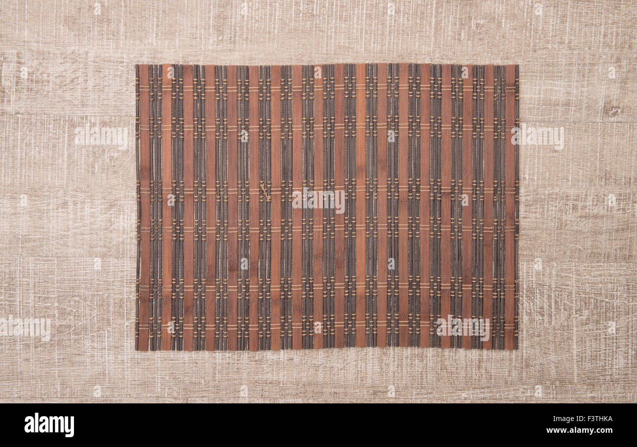 Bamboo place mat on wooden deck table Stock Photo - Alamy