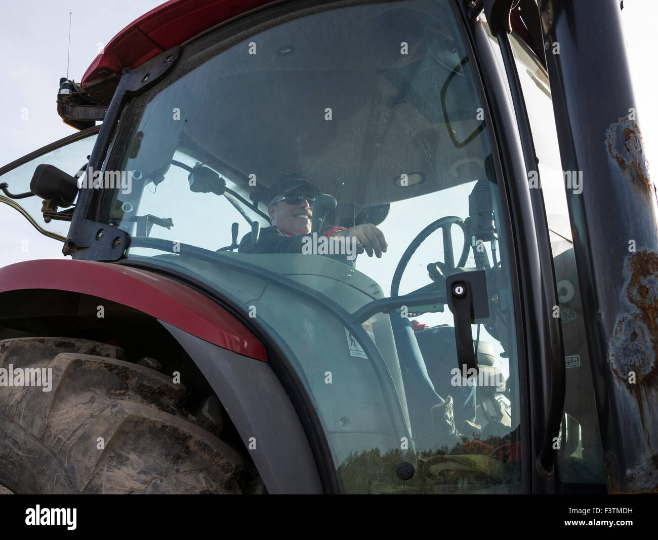 A farmer in a tractor Stock Photo - Alamy