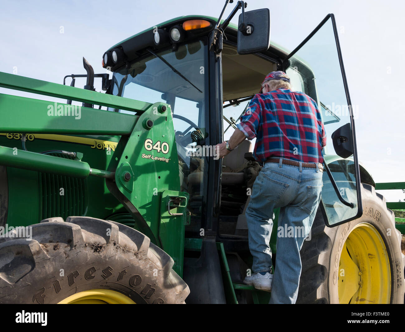 A farmer in a tractor Stock Photo - Alamy