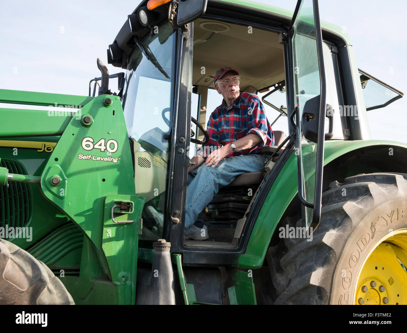A farmer in a tractor Stock Photo - Alamy