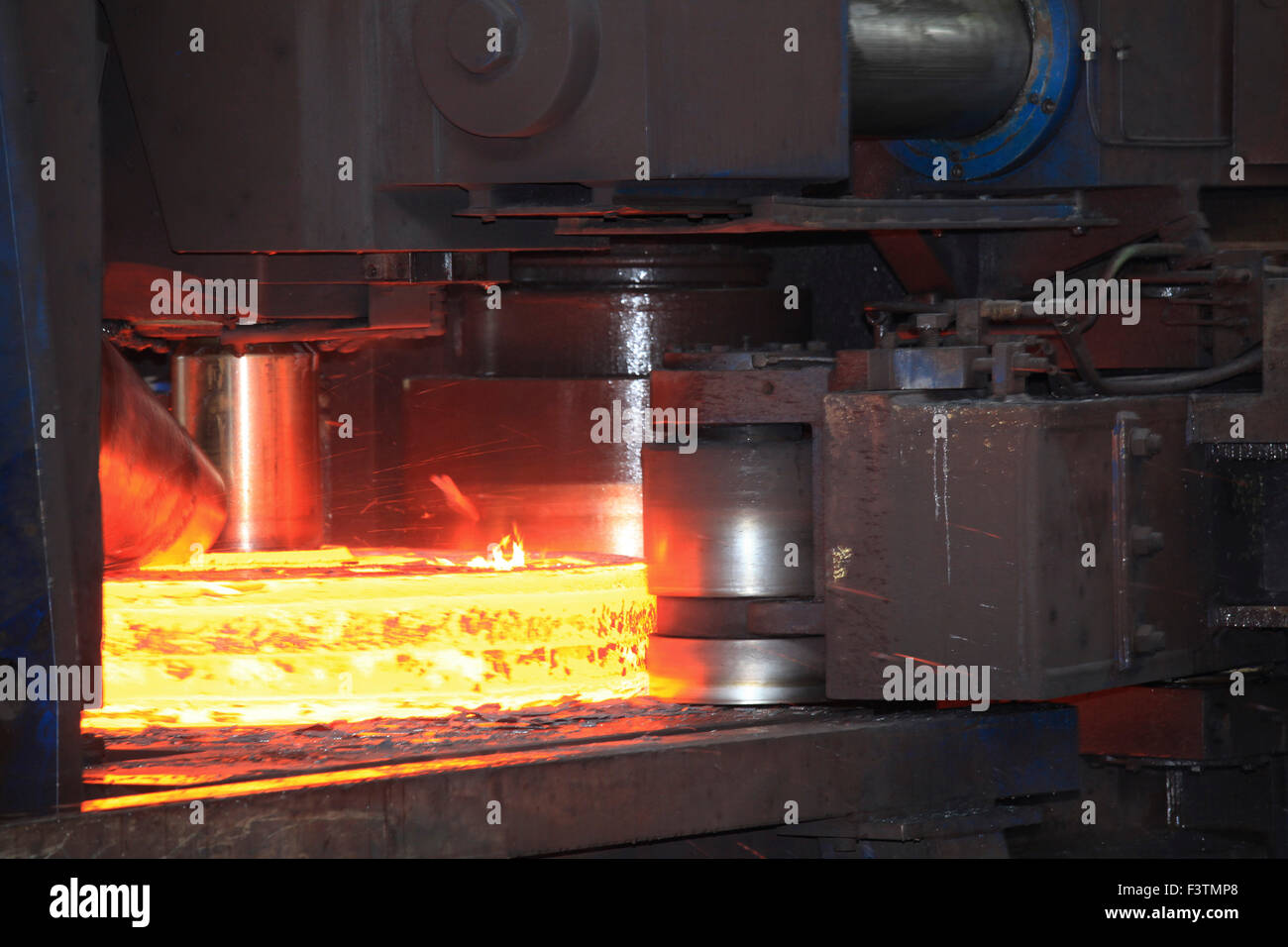 Heated metal pig gets squeezed and drilled at special metal forging ...