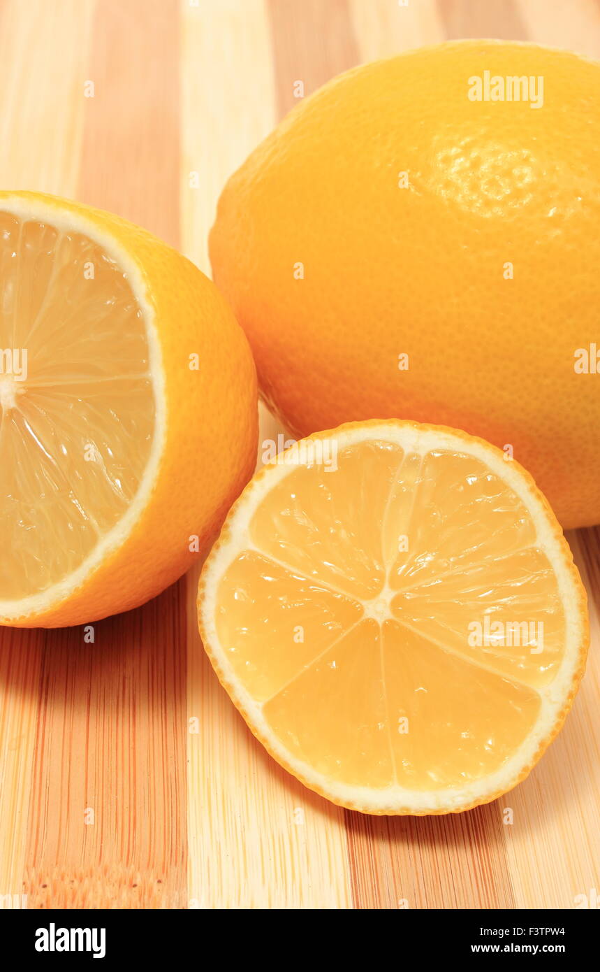 Whole and half of fresh lemons on wooden background, citrus, concept ...