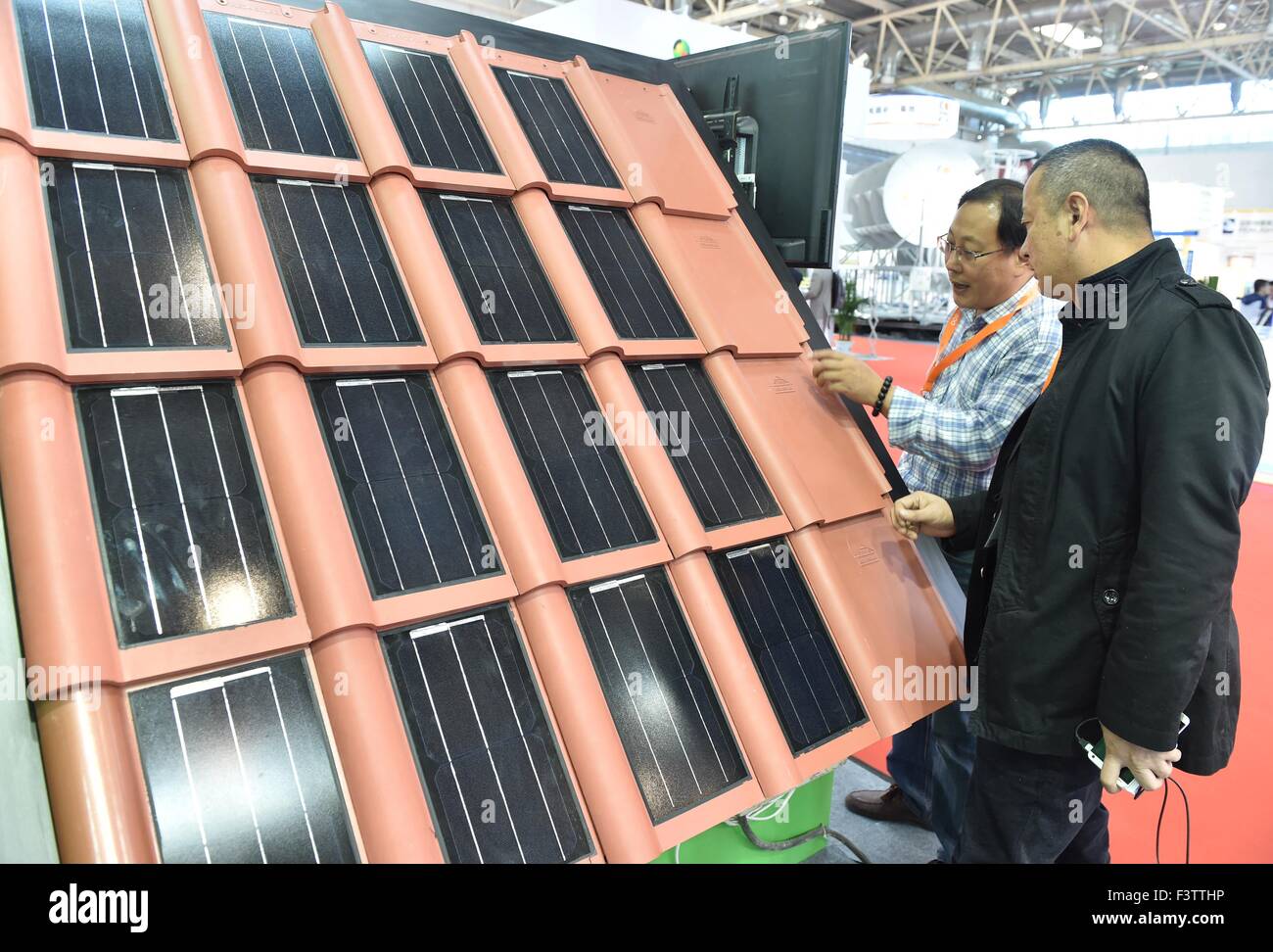 Beijing, China. 13th Oct, 2015. Visitors view solar-power tiles at the ...