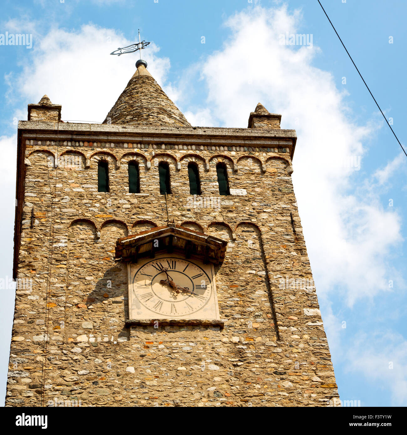 ancien clock tower in italy europe old stone and bell Stock Photo - Alamy