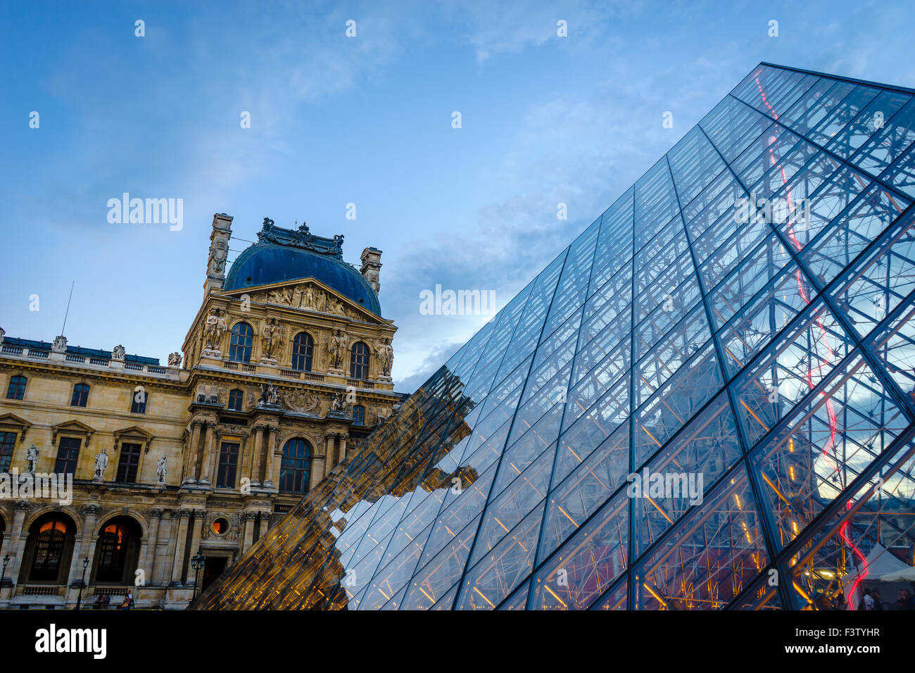 Close-up view of the Louvre Museum's pyramid during sunset. Paris ...