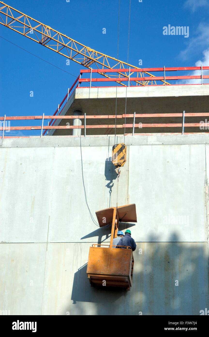 Construction workers in gondola Stock Photo - Alamy