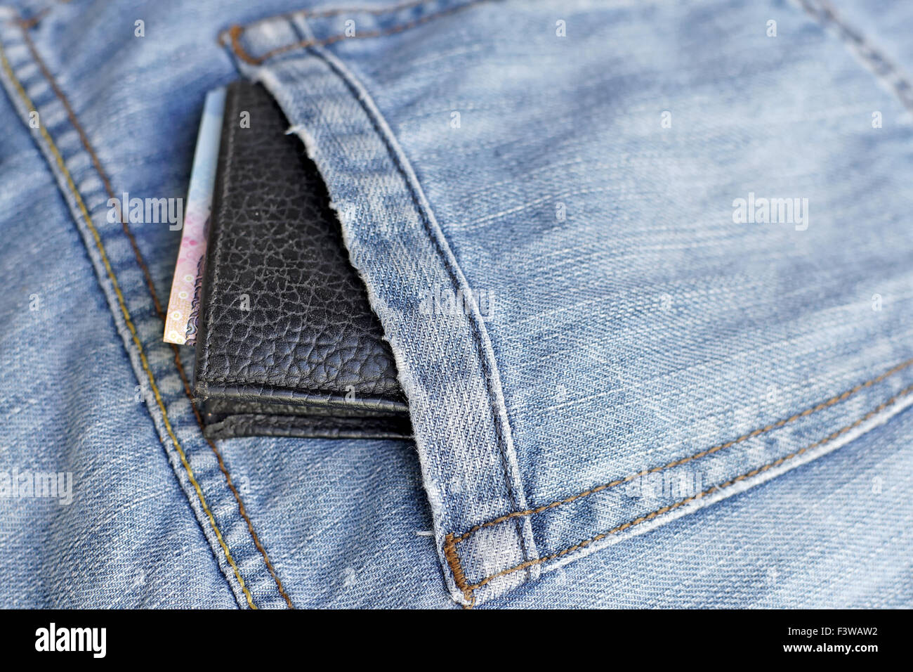 old wallet in back pocket blue jeans Stock Photo - Alamy