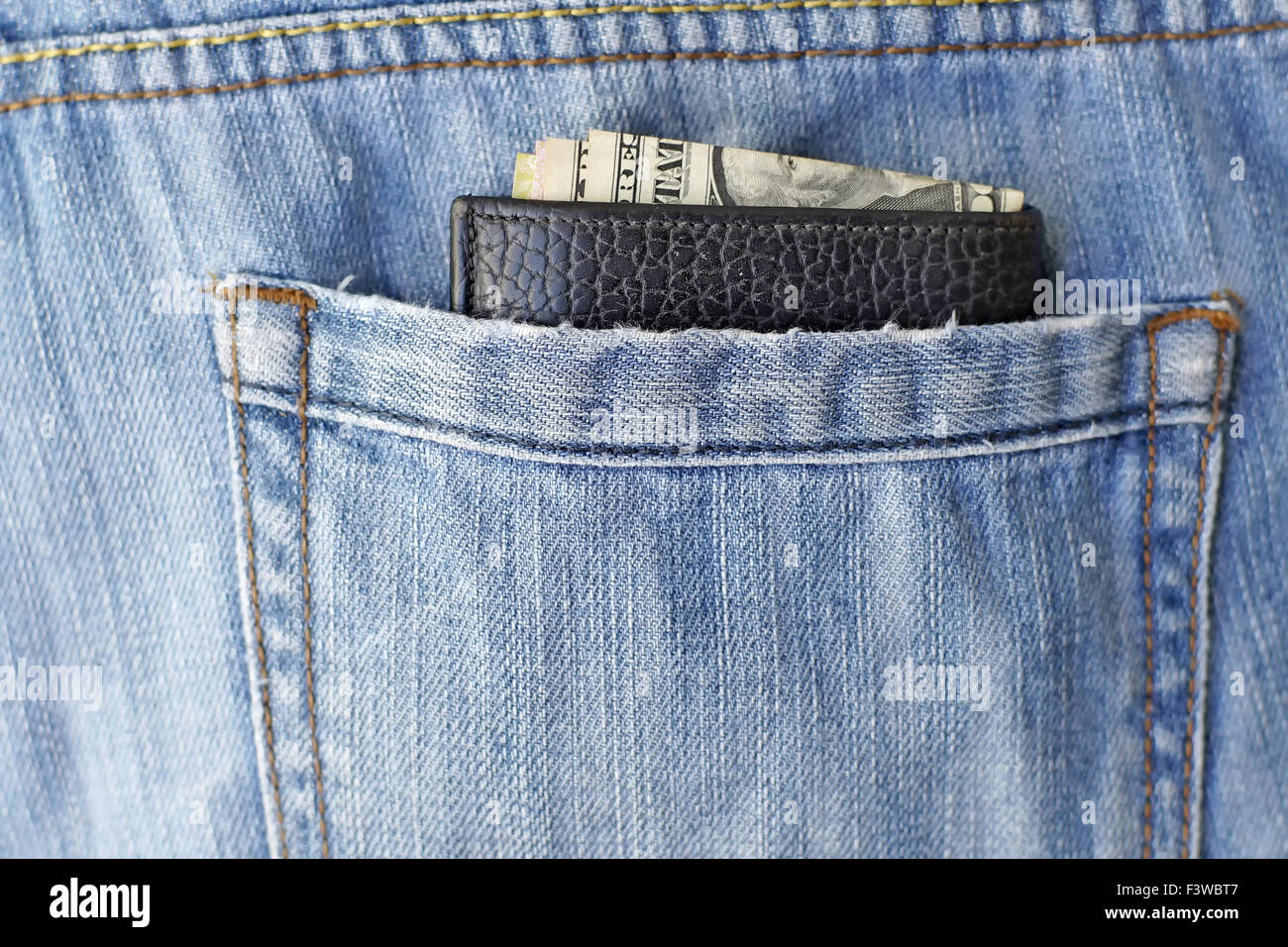 old wallet in back pocket blue jeans Stock Photo - Alamy