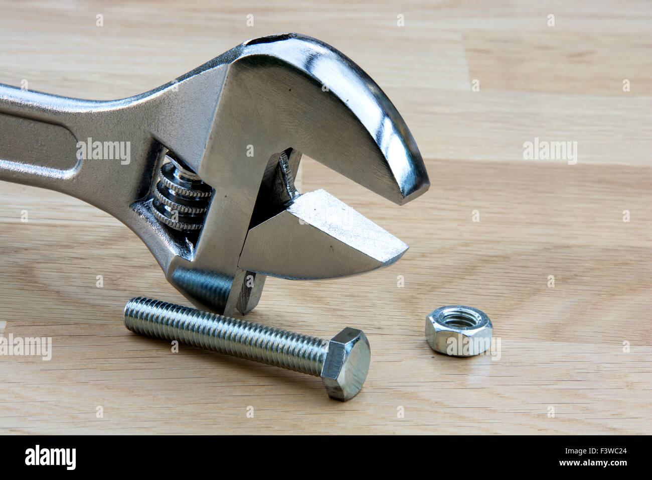 Adjustable wrench with nut and bolt Stock Photo - Alamy