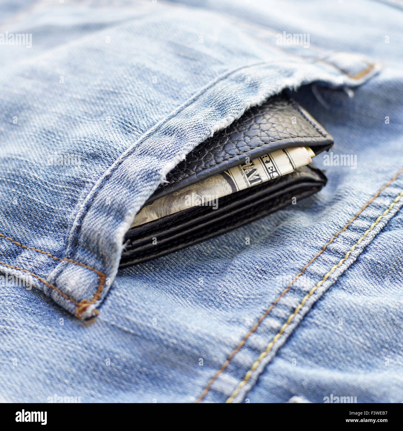 old wallet in back pocket blue jeans Stock Photo - Alamy
