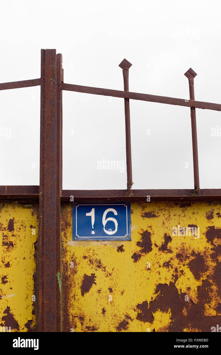 Metal door with number sixteen on it Stock Photo - Alamy