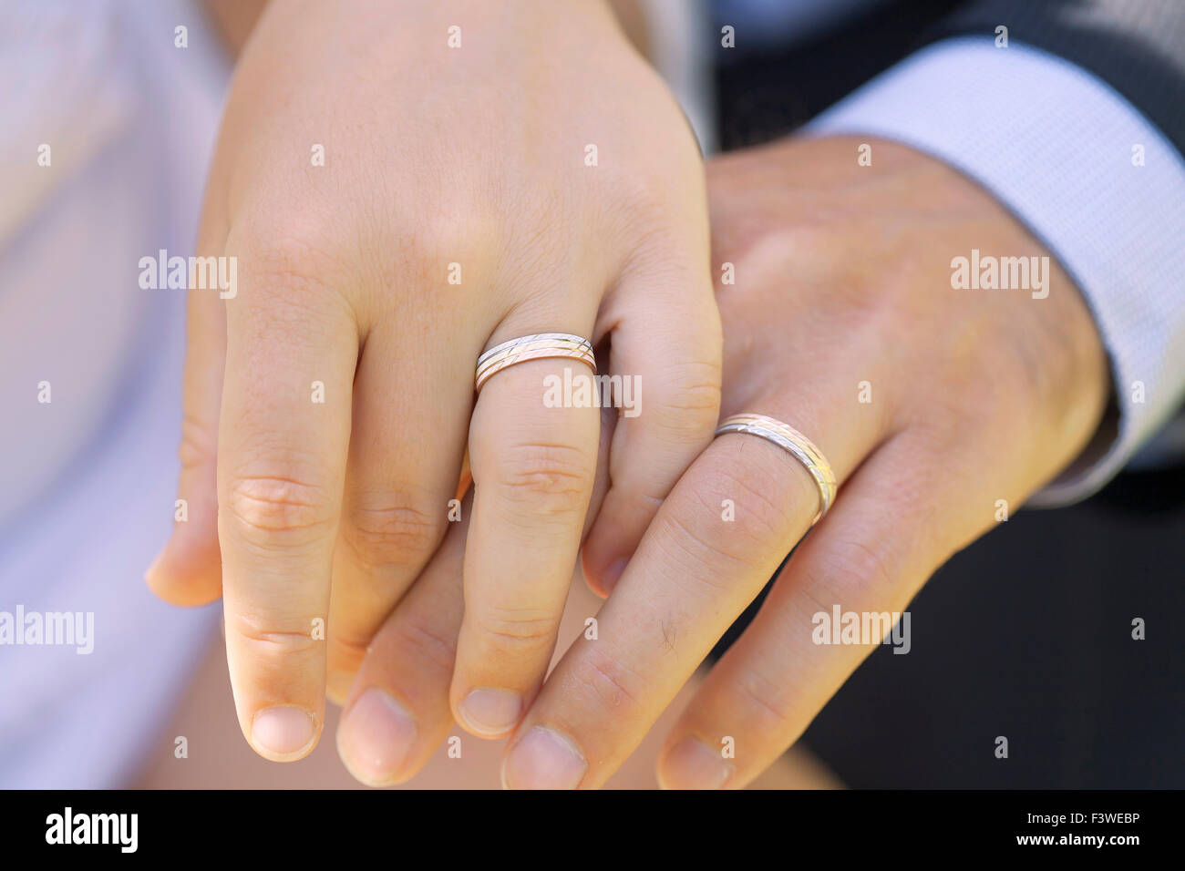 Newly wed couple's hands with wedding rings Stock Photo - Alamy