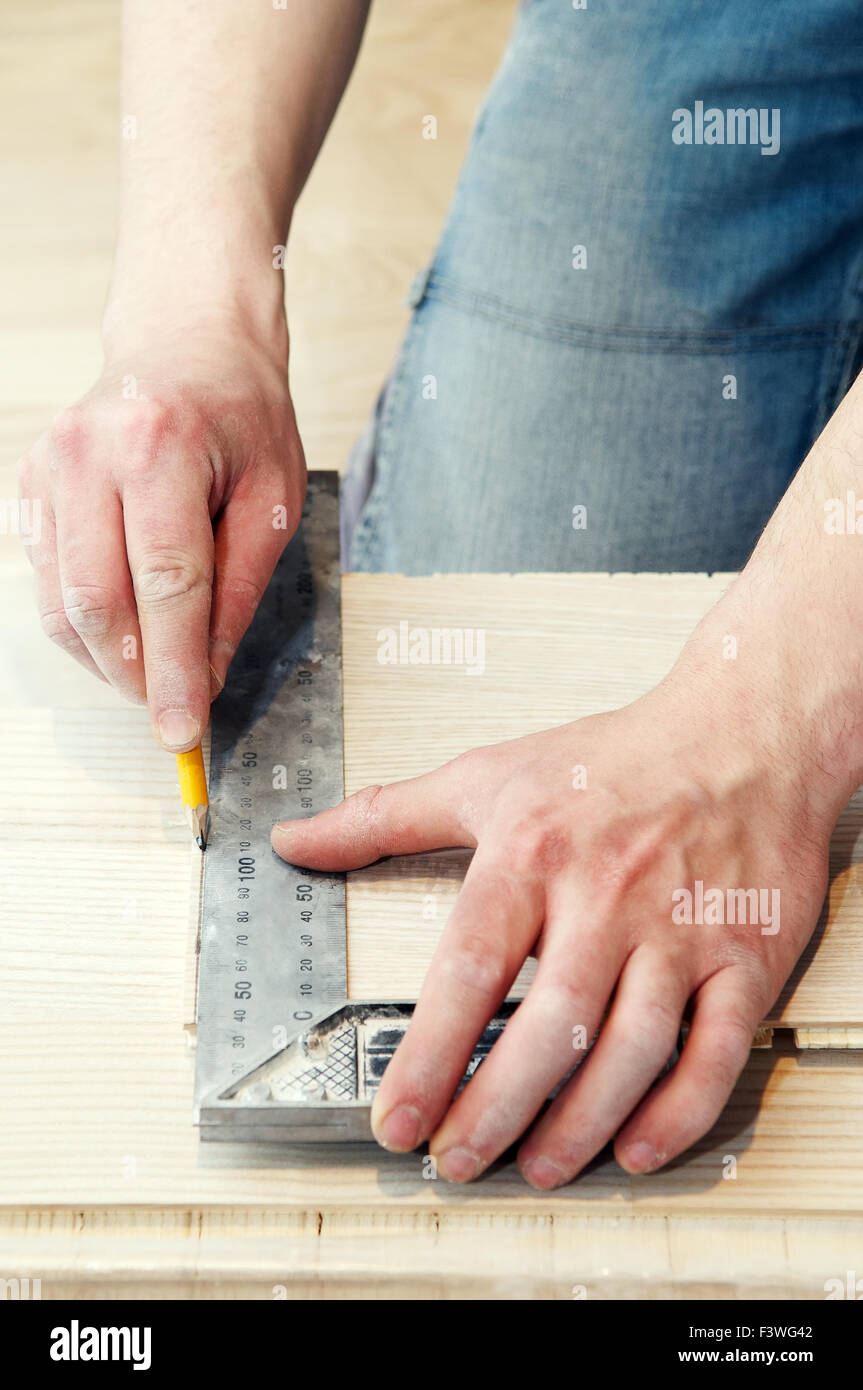 carpenter works using metal angle Stock Photo - Alamy