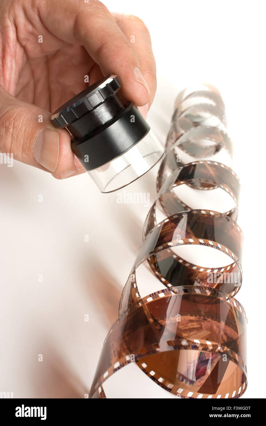hand holding magnifying glass and film Stock Photo - Alamy