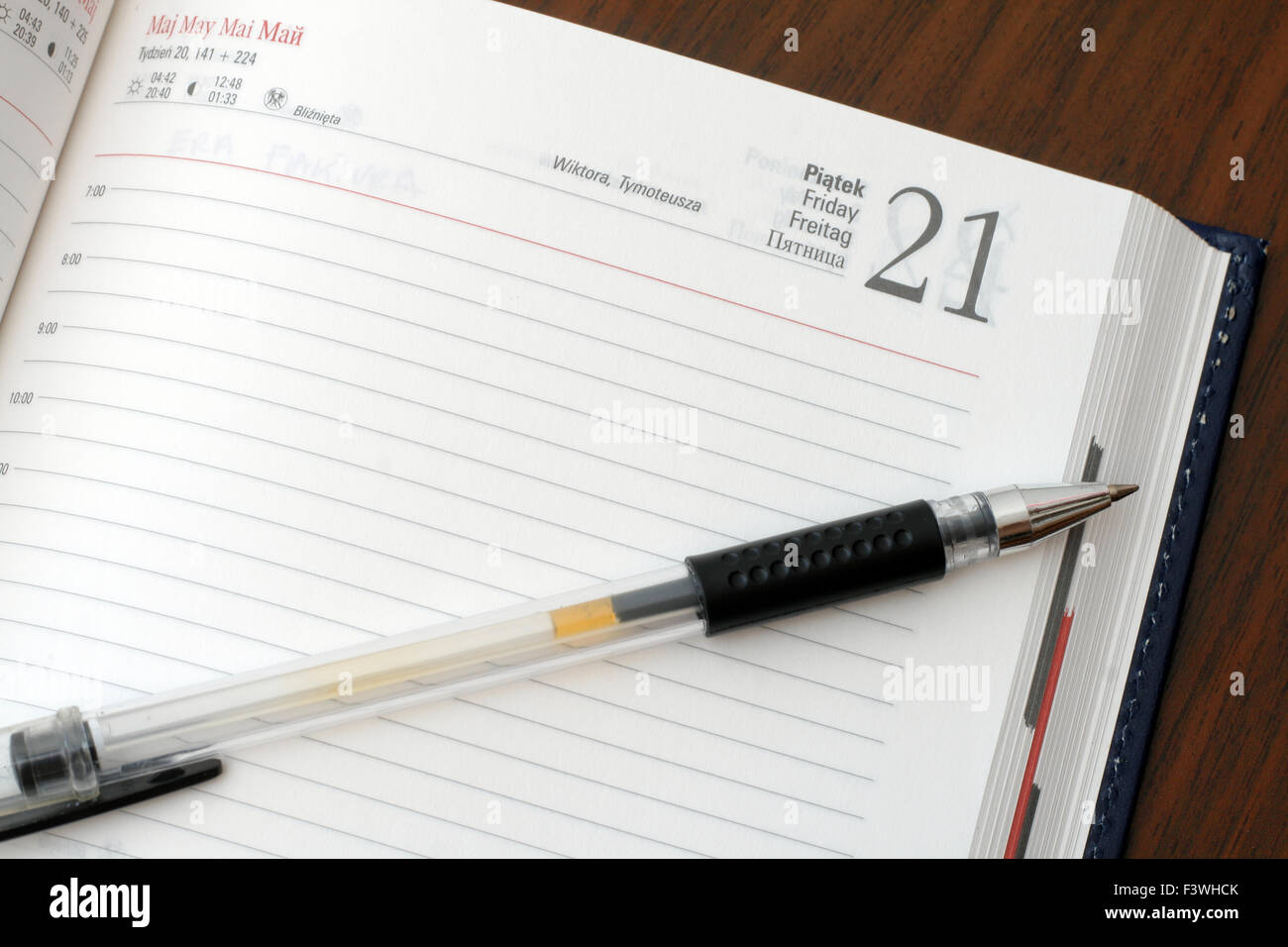 Diary and a pen on wooden table Stock Photo - Alamy