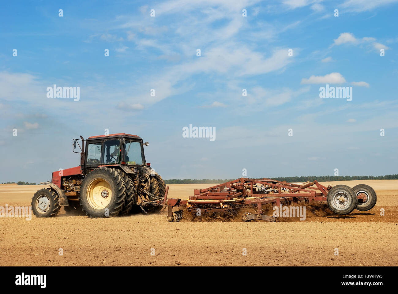 Agriculture ploughing tractor outdoors Stock Photo - Alamy
