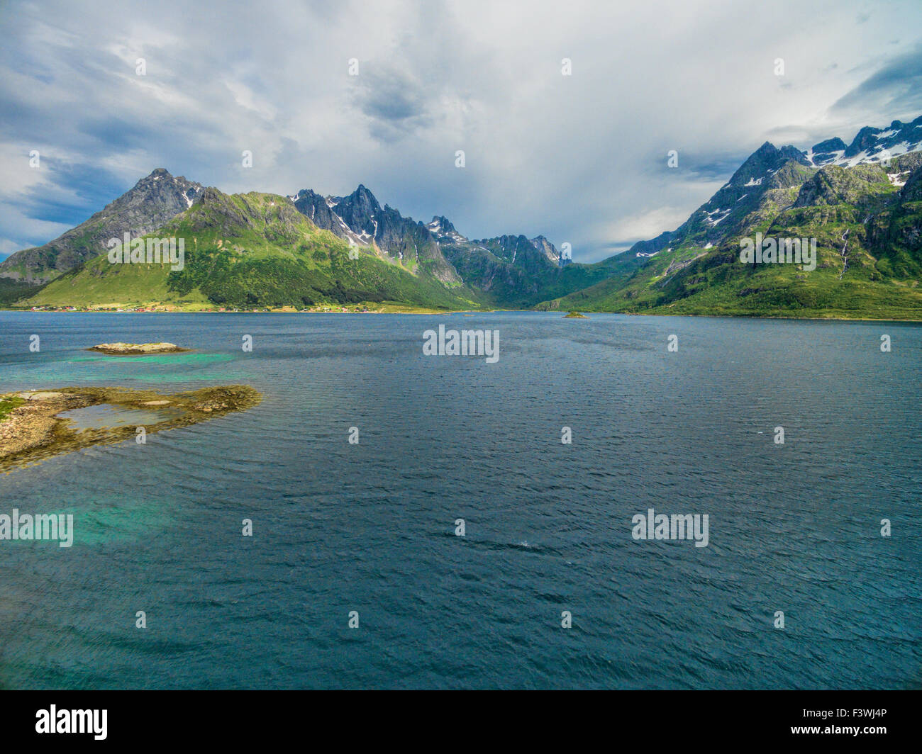Beautiful mountain peaks surrounding deep fjord on Lofoten islands in ...