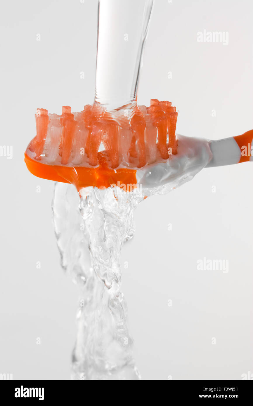 water flows to the toothbrush Stock Photo - Alamy