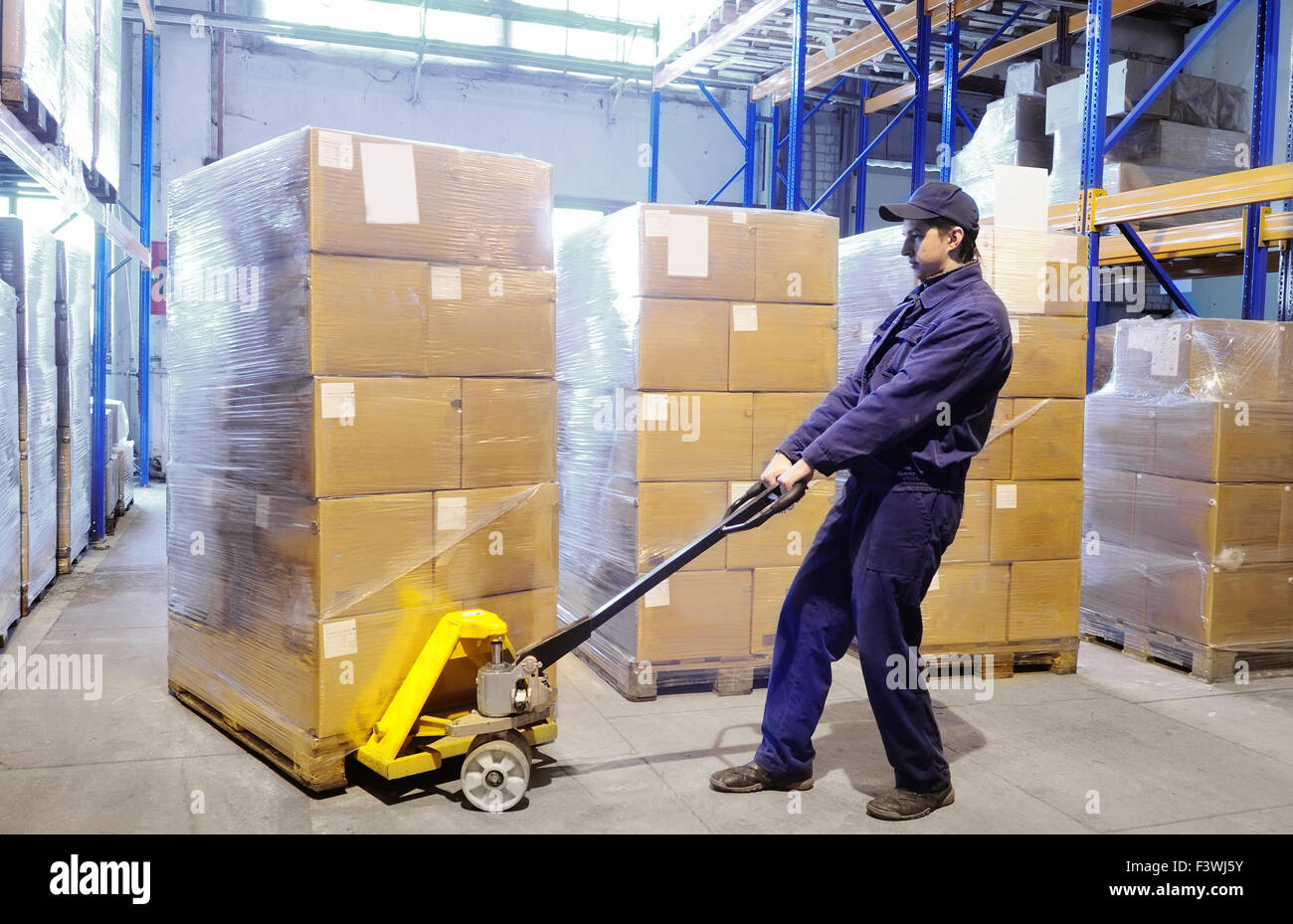 worker with stacker at warehouse Stock Photo - Alamy