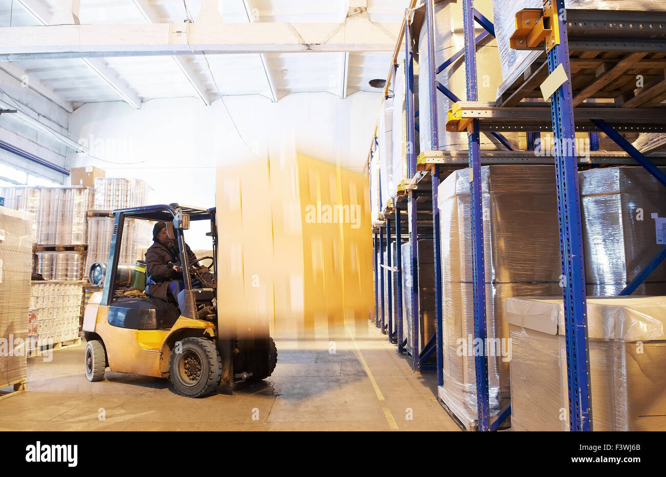 at a warehouse with forklift loader Stock Photo - Alamy