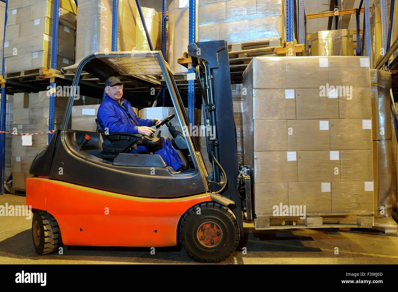 forklift loader worker at warehouse Stock Photo - Alamy