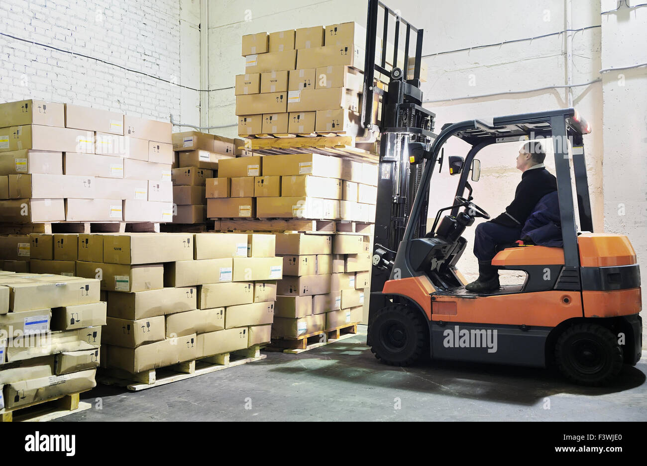 Forklift loader in warehouse Stock Photo - Alamy