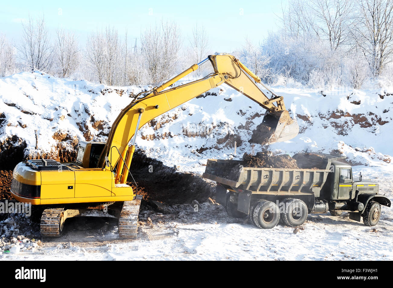 loader excavator and rear-end tipper Stock Photo - Alamy