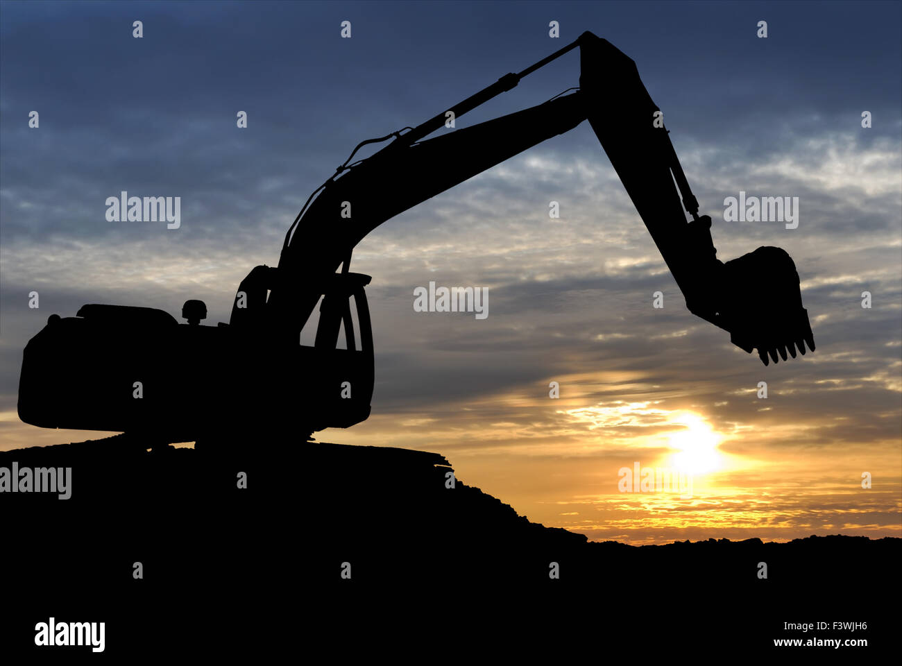 Loader excavator over sunset Stock Photo - Alamy