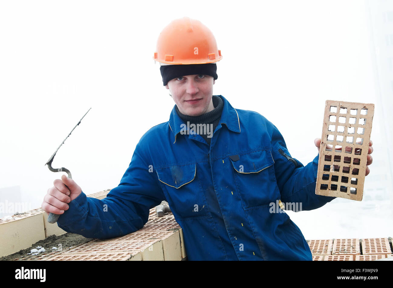 Brick layer worker builder mason Stock Photo - Alamy