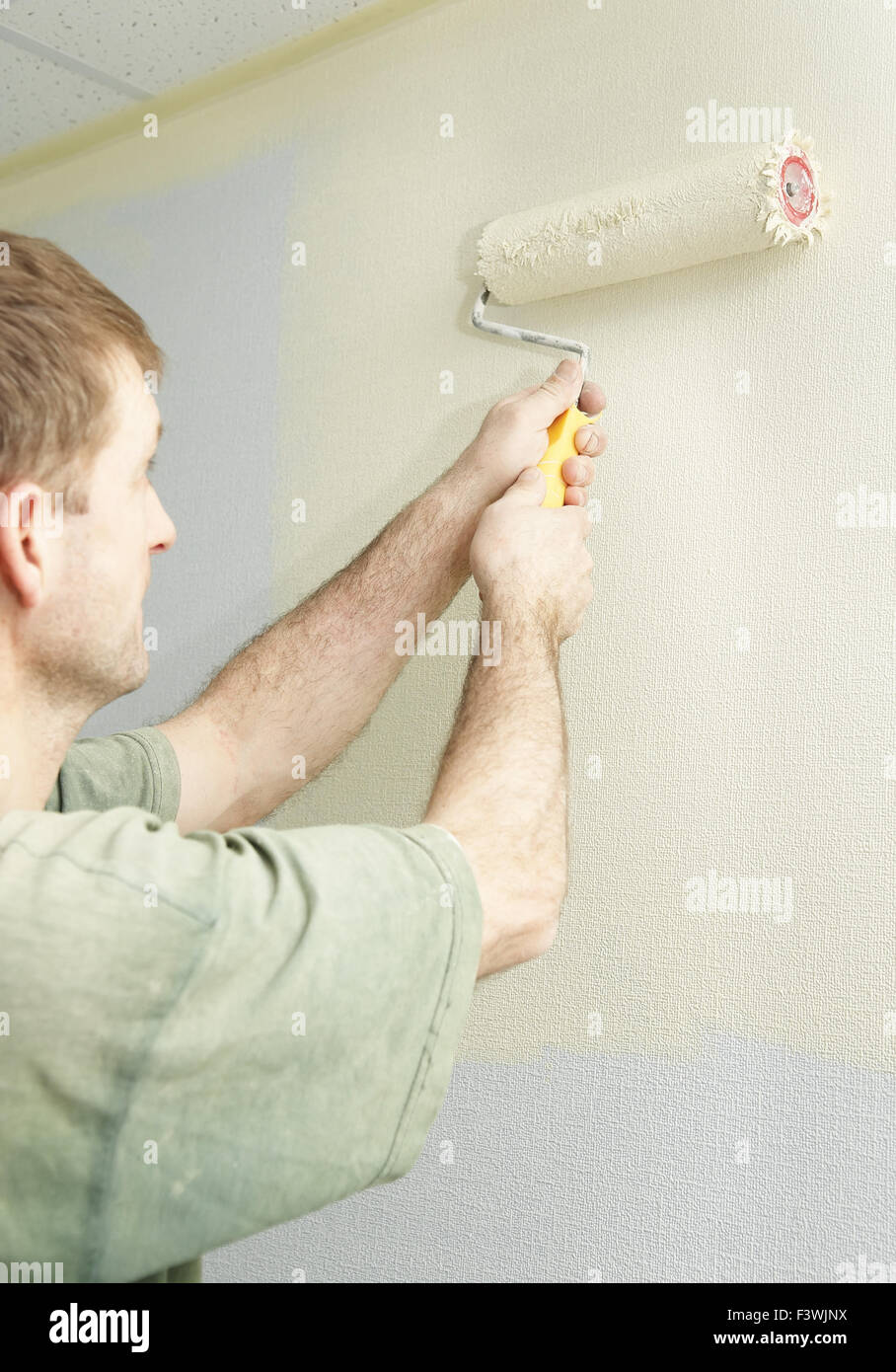 Painter worker with roller Stock Photo - Alamy