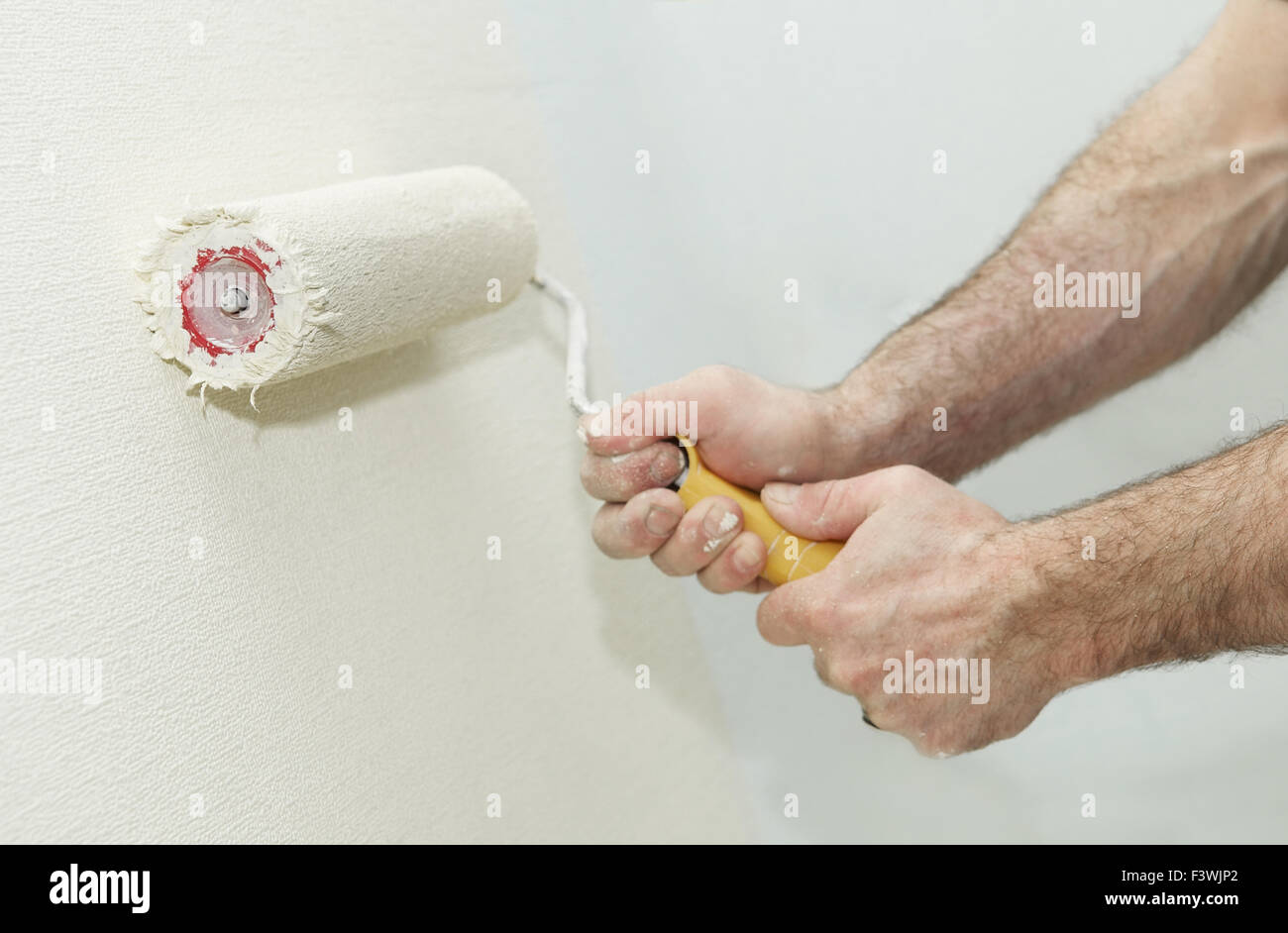 Painter worker hand with roller Stock Photo - Alamy