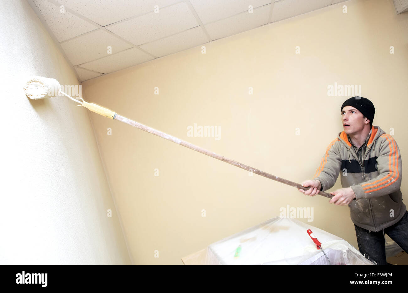 Painter worker with roller Stock Photo - Alamy