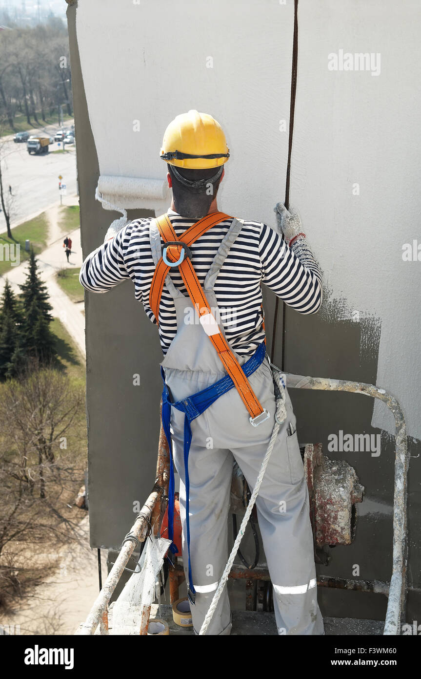 builder facade painter at work Stock Photo - Alamy
