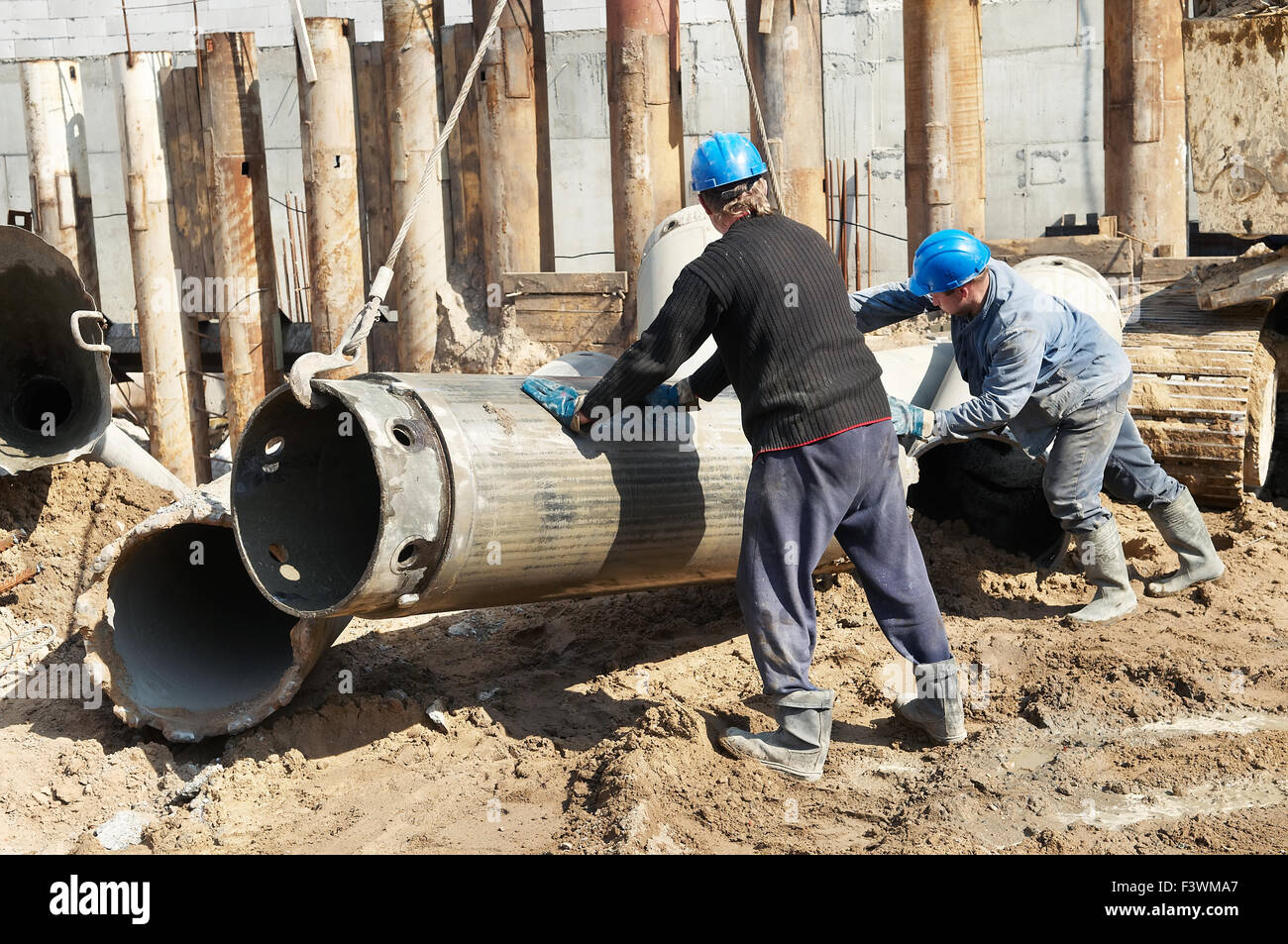 builders with equipment for piling Stock Photo - Alamy