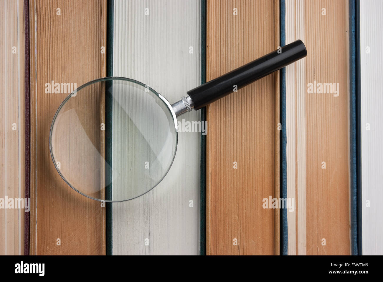 books and magnifying glass Stock Photo - Alamy