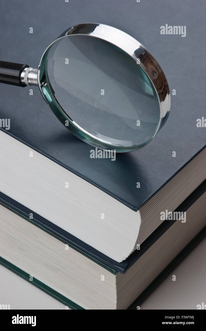 books and magnifying glass Stock Photo - Alamy