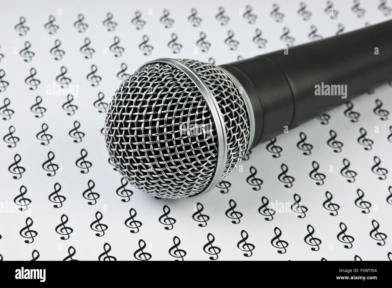 microphone on background of the treble clef Stock Photo - Alamy