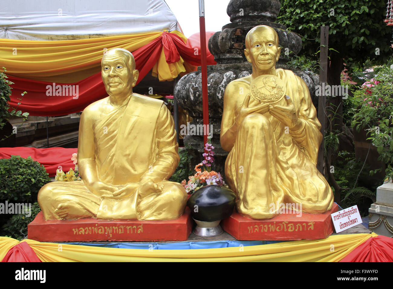 Two golden monks Stock Photo - Alamy