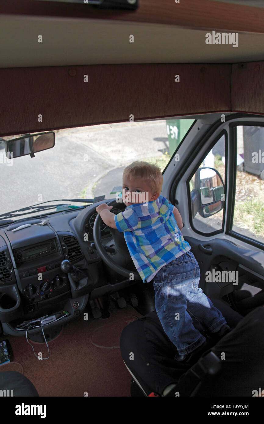 Toddler driving stationary motorhome Stock Photo - Alamy