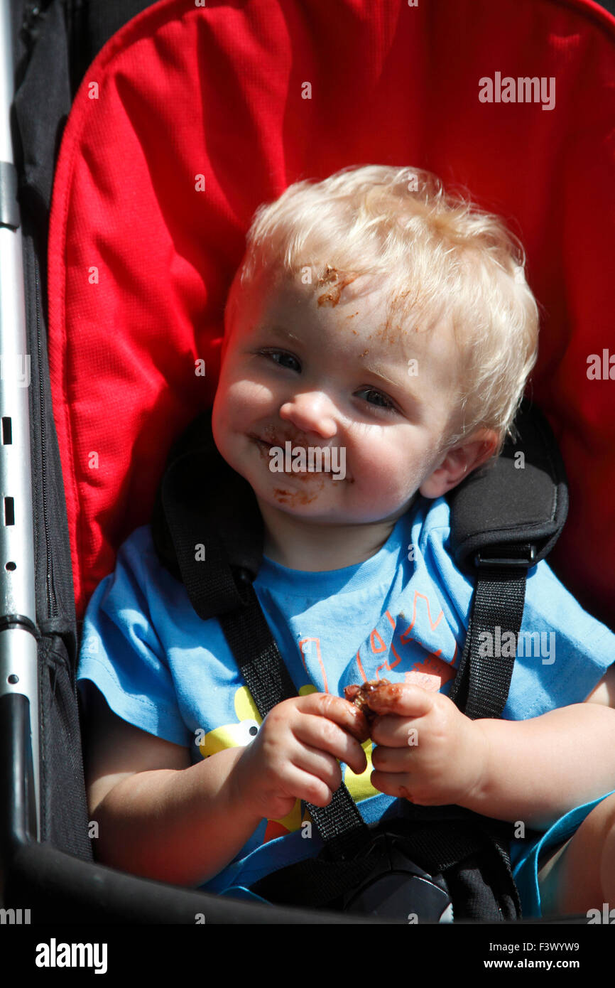 Toddler eating chocolate biscuit Stock Photo - Alamy